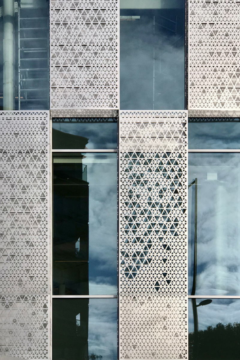 A facade clad in perforated aluminum panels